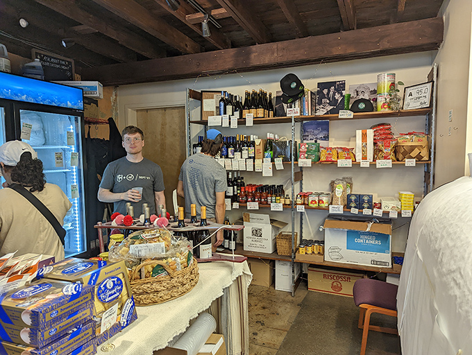 Inside, rustic wooden beams watch over a carefully curated grocery selection. This is the neighborhood spot where sandwich magic happens behind the counter.