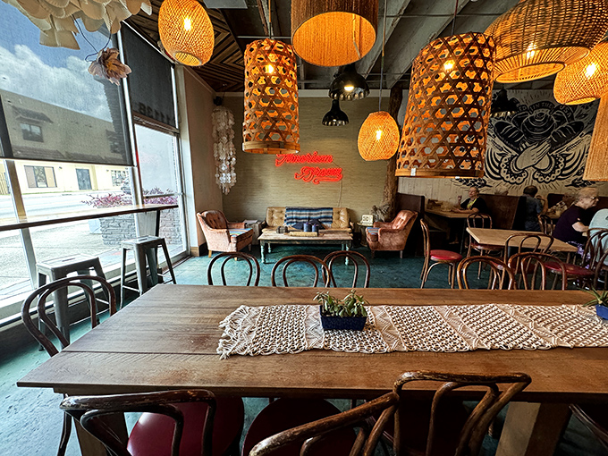 Woven pendant lights hang like artisanal cocoons above wooden tables, creating the perfect atmosphere for serious pastry contemplation.
