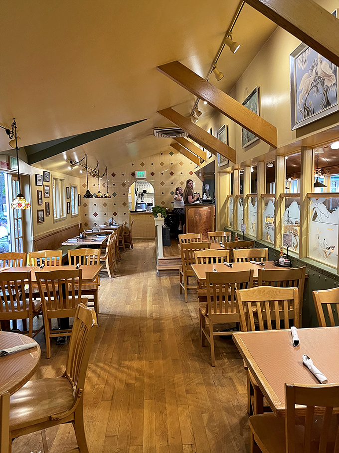 Inside, wooden beams and warm lighting create the perfect backdrop for comfort food conversations. The dining room feels like a well-loved family cabin.
