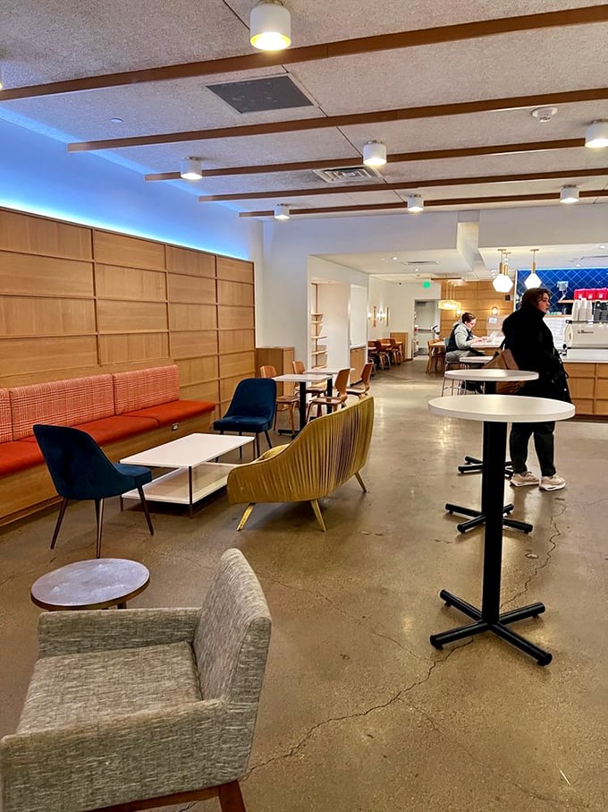 Modern meets cozy in this thoughtfully designed space where wood paneling and stylish seating create the perfect backdrop for donut contemplation.