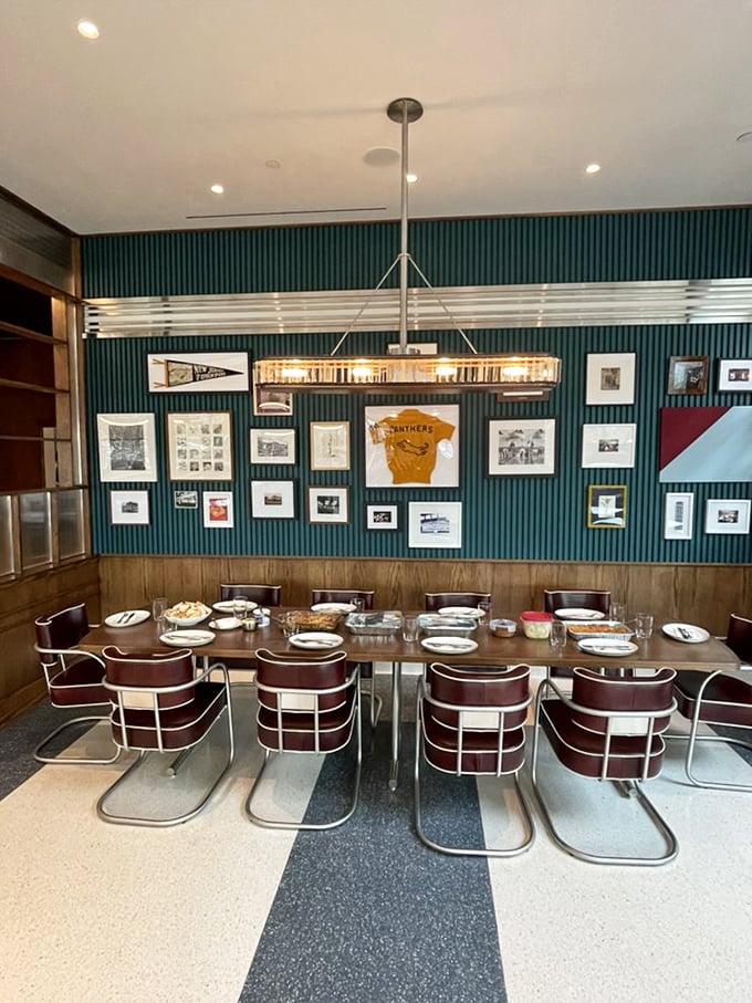 Mid-century modern meets contemporary cool in this dining area where teal walls and burgundy chairs create the perfect backdrop for life-changing pancakes.