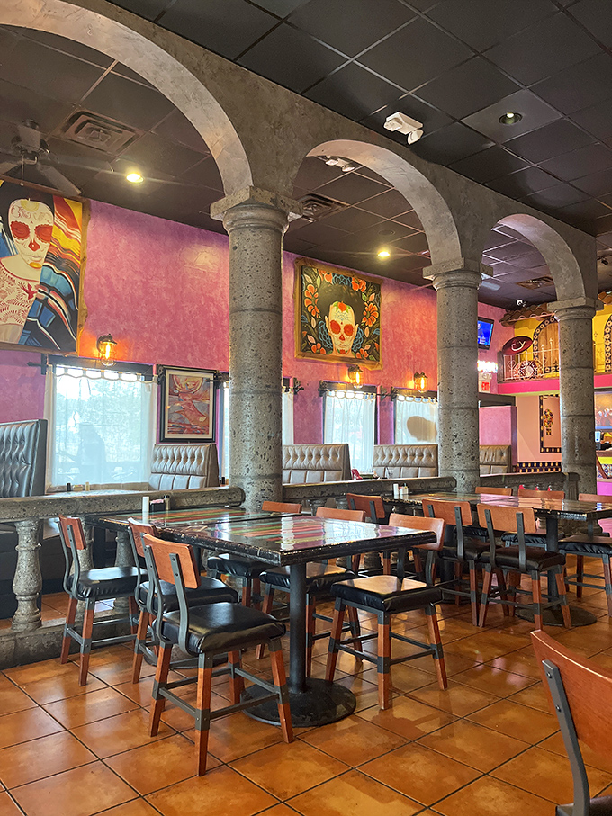 Stone archways frame the dining experience like portals to Mexico, while vibrant Day of the Dead artwork watches over happy diners.