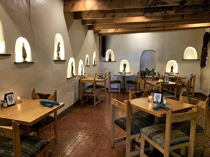 Step inside and time travels backward—illuminated wall niches, exposed beams, and brick floors that have witnessed decades of memorable meals.