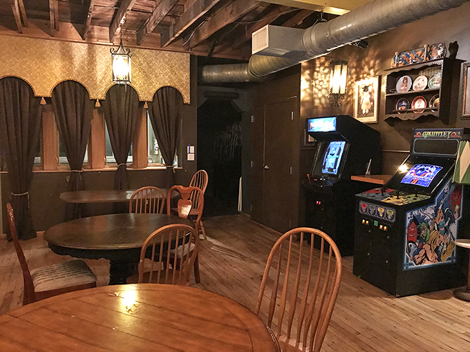 Wooden tables, vintage arcade cabinets, and exposed beams create the perfect atmosphere for nostalgic gaming sessions fueled by craft cocktails.