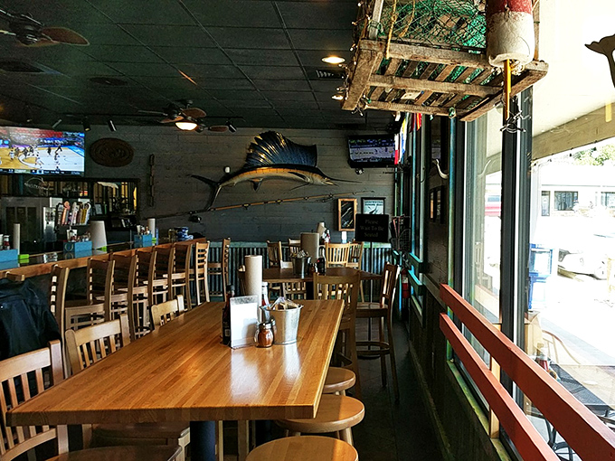 Nautical charm flows through every detail, from the impressive marlin on the wall to wooden tables that practically invite you to crack open some crab legs.