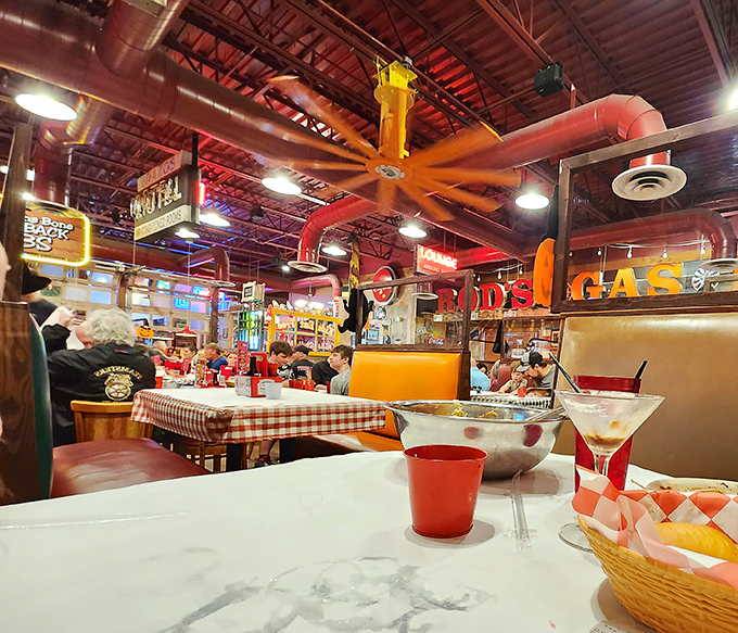 Step inside and the nostalgia hits harder than the aroma of sizzling steaks. Industrial pipes painted in carnival colors create the perfect backdrop for serious eating.
