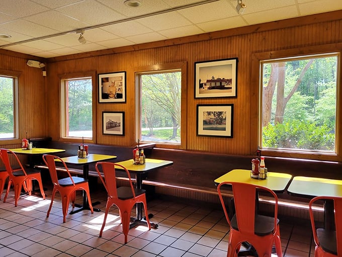 Wood-paneled walls tell fifty years of stories while those orange chairs invite you to create your own barbecue memories.