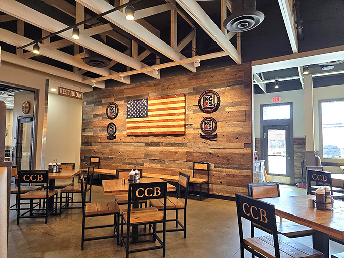 Rustic meets refined in this dining space where competition badges tell tales of barbecue glory and that wooden American flag stands proudly over meat masterpieces.
