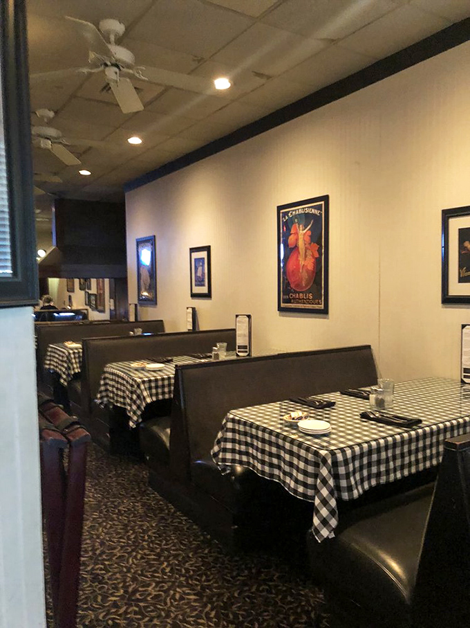 Classic booths with checkered tablecloths set the stage for culinary nostalgia. No Edison bulbs or reclaimed wood here &ndash; just comfortable seating for serious eating.