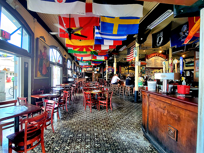International flags create a colorful canopy above the bar, as if the United Nations decided to throw a party in Key West.