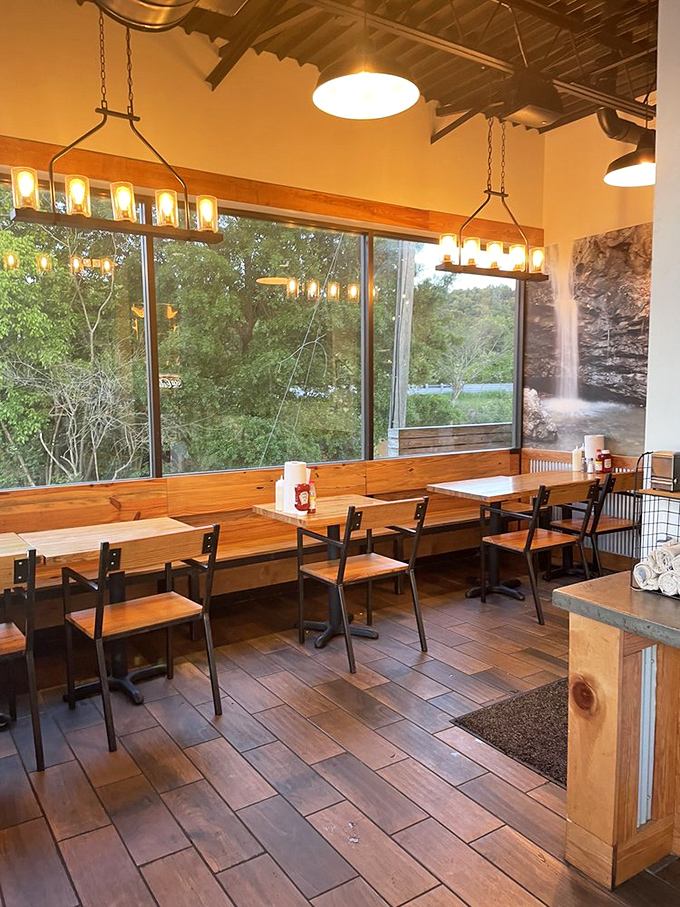 Nature becomes part of the dining experience with floor-to-ceiling windows that make every meal feel like an upscale picnic in the woods.