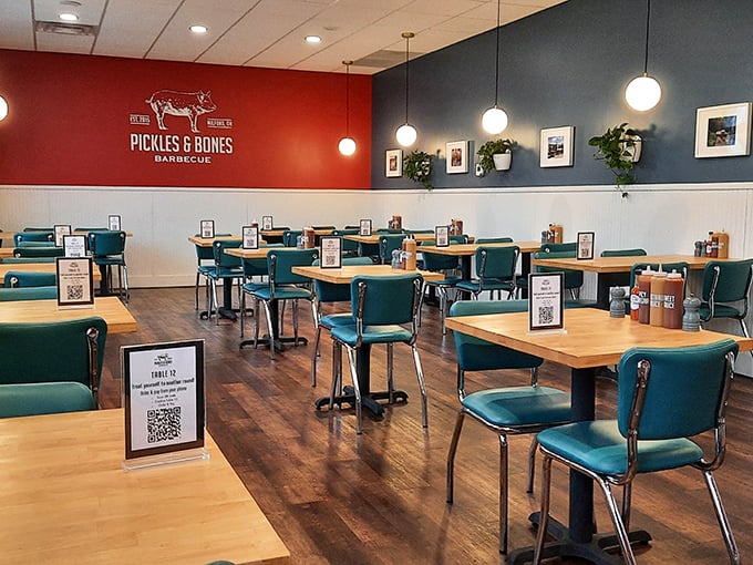 Modern meets homestyle in this thoughtfully designed dining room, where teal chairs and warm wood create the perfect backdrop for serious meat appreciation.