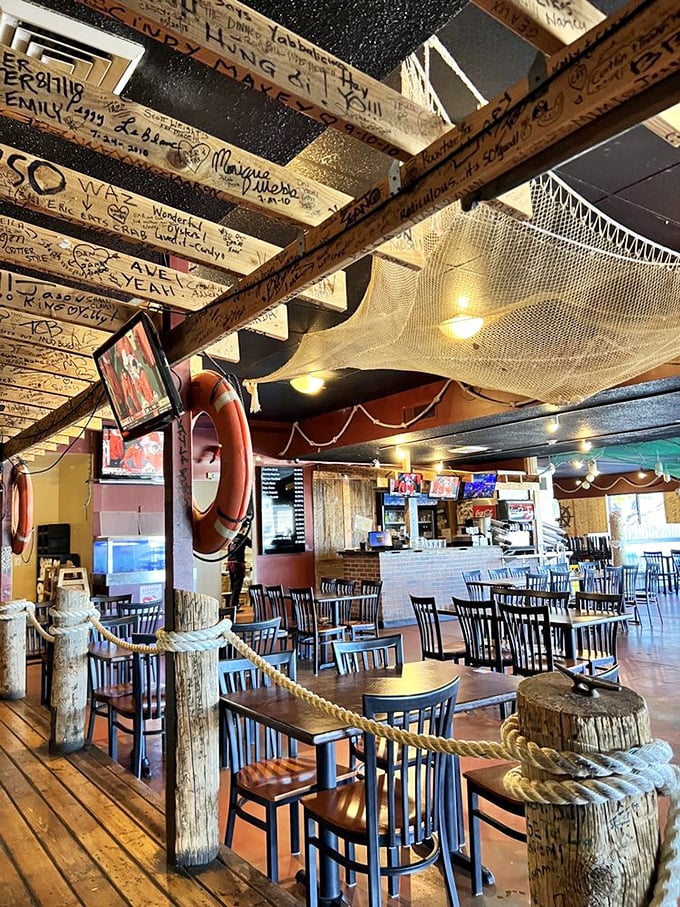 Fishing nets overhead and wooden beams covered with signatures create a maritime clubhouse vibe. Every beam tells a story&mdash;some probably involving "the one that got away."