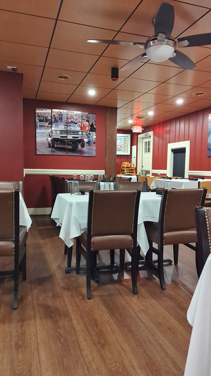 Red walls, white tablecloths, and leather chairs create that perfect sweet spot between "fancy enough for your anniversary" and "comfortable enough to actually enjoy your meal."