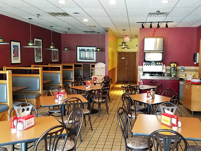 Step into flavor town! The cozy interior, with its warm red walls and inviting booths, sets the stage for a finger-licking good time.