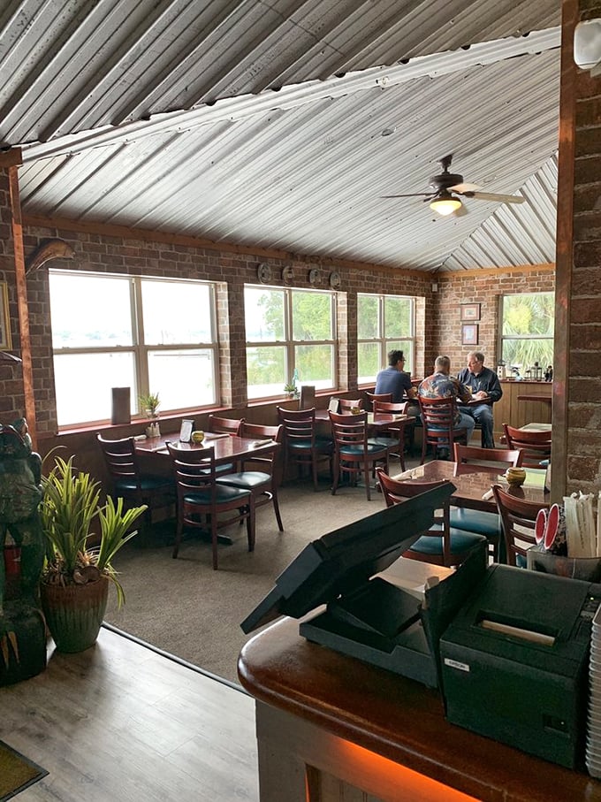 Exposed brick walls, wooden beams, and water views create that rare trifecta of dining ambiance – rustic, comfortable, and authentically Floridian.