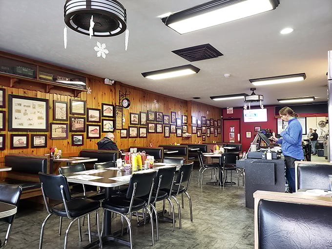 Wood-paneled walls covered in decades of local memorabilia create the perfect backdrop for comfort food conversations. This isn't decoration&mdash;it's Huntington's community scrapbook.