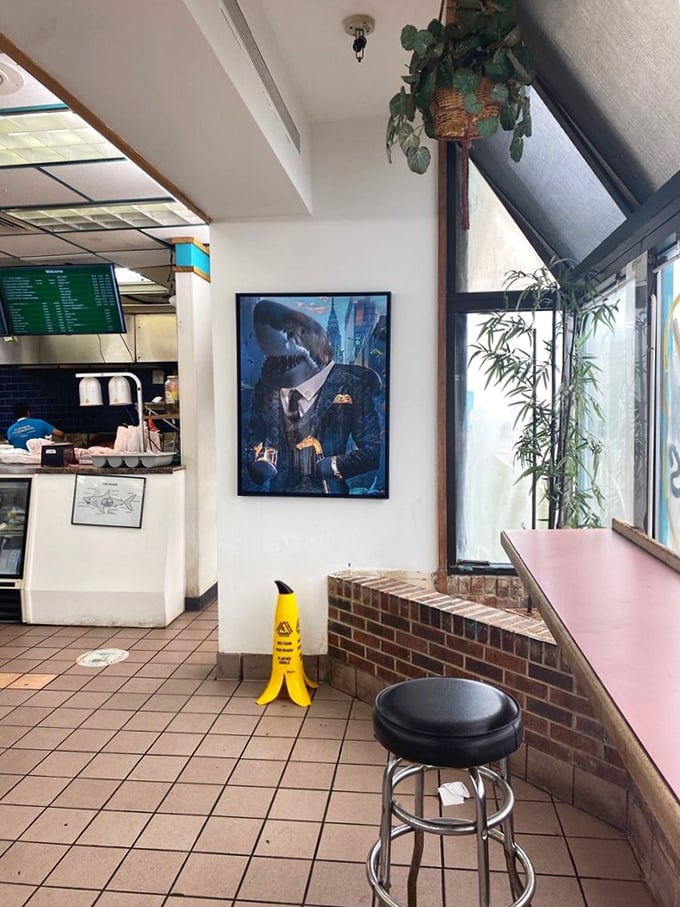 That shark-in-a-suit artwork isn't just decoration&mdash;it's a warning that you're about to experience some seriously dressed-up flavors in this no-frills setting.
