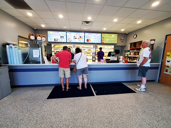 Morning pilgrims line up at the counter, participating in a time-honored Pennsylvania ritual: the strategic acquisition of fresh donuts.