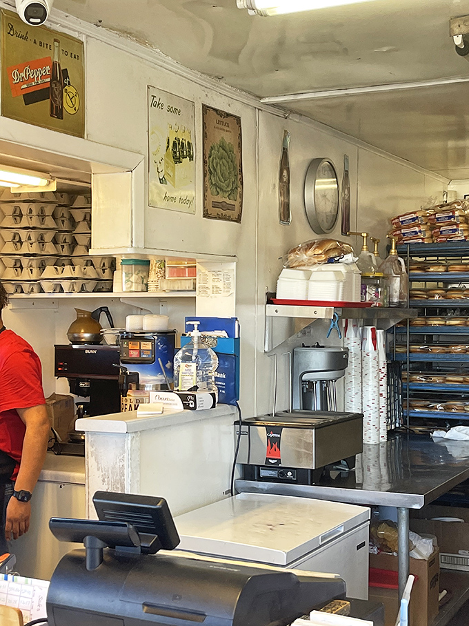 Behind the counter, vintage soda signs and well-worn equipment tell the story of decades dedicated to the perfect patty.