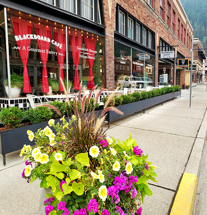 The Blackboard Caf&eacute;'s vibrant red curtains and lush planters invite you in like an old friend saying, "Come on, I saved you a seat."