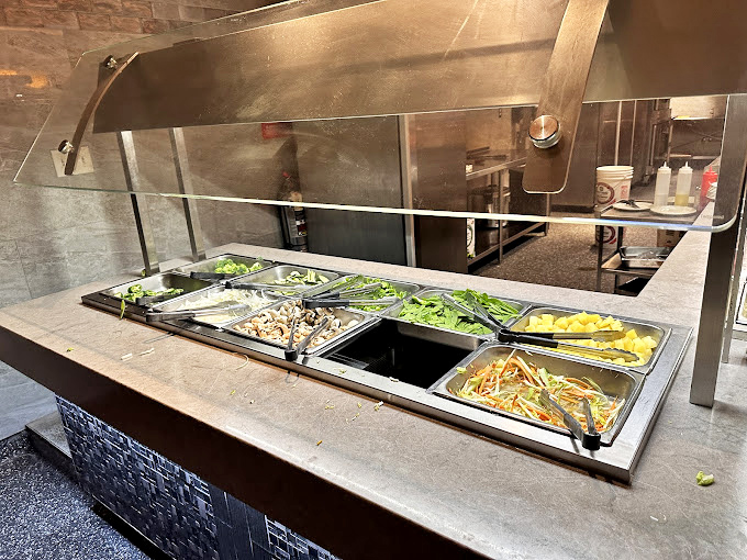 Fresh ingredients await their transformation at the hibachi station, where vegetables maintain that perfect crunch before meeting their delicious destiny.
