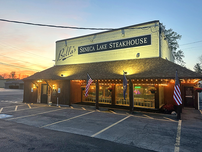 Bella's wooden exterior at sunset&mdash;where Finger Lakes magic meets meat mastery. Napa Valley, eat your heart out.