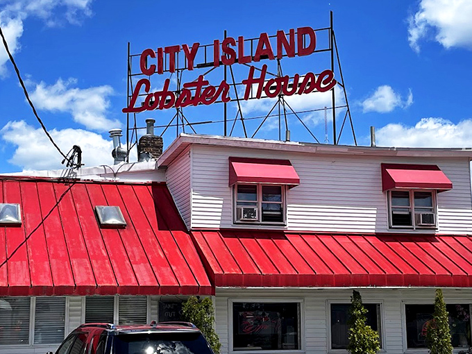 That bold red roof and vintage neon sign aren't just for show—they're promising you the kind of lobster feast that makes everyday problems disappear.