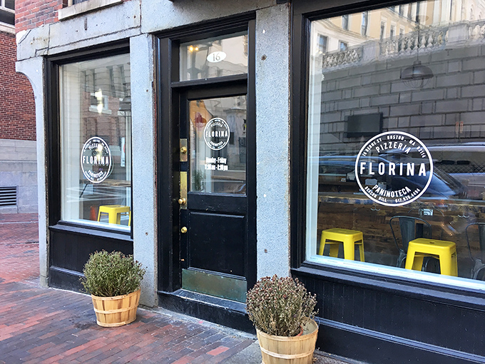FLORINA Pizzeria & Paninoteca: "Minimalist storefront, maximalist flavors. Those yellow stools aren't just seating—they're front-row tickets to pizza perfection."