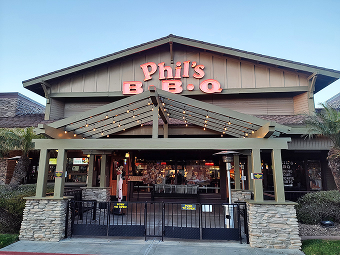 Phil's BBQ's lodge-like entrance beckons with the subtle glow of string lights&mdash;nature's way of saying "follow me to the ribs."