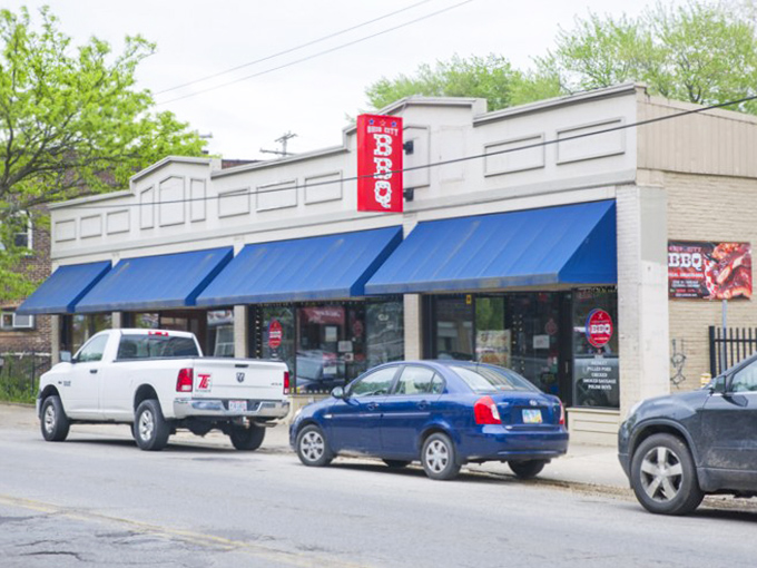 Real Smoq'ed BBQ's storefront might be modest, but that "Open" sign is the gateway to flavor town.