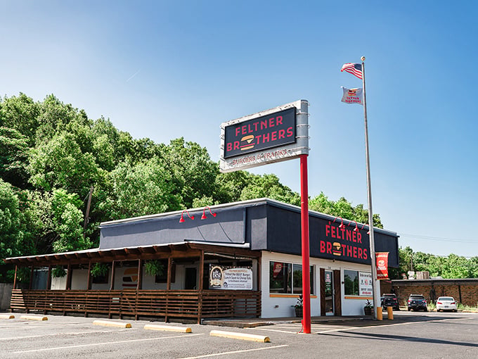 Summer perfection: A proud flag waves above Feltner Brothers, where hot dog dreams come true beneath the Arkansas sky.