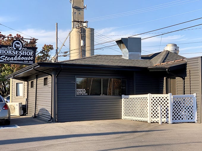 Horseshoe Steakhouse (front view): "Small building, big flavors. The white lattice fence isn't keeping a secret that's this delicious."