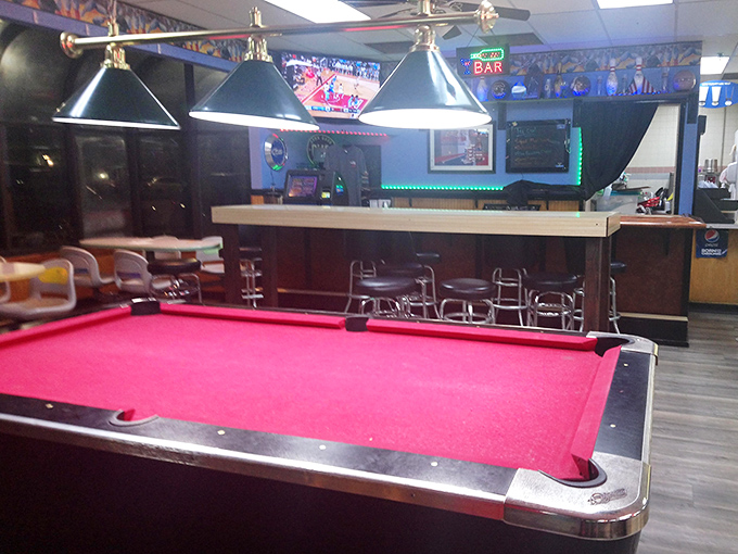 The vibrant red pool table offers the perfect between-frames diversion&mdash;proof that this place understands entertainment isn't just about knocking down pins.