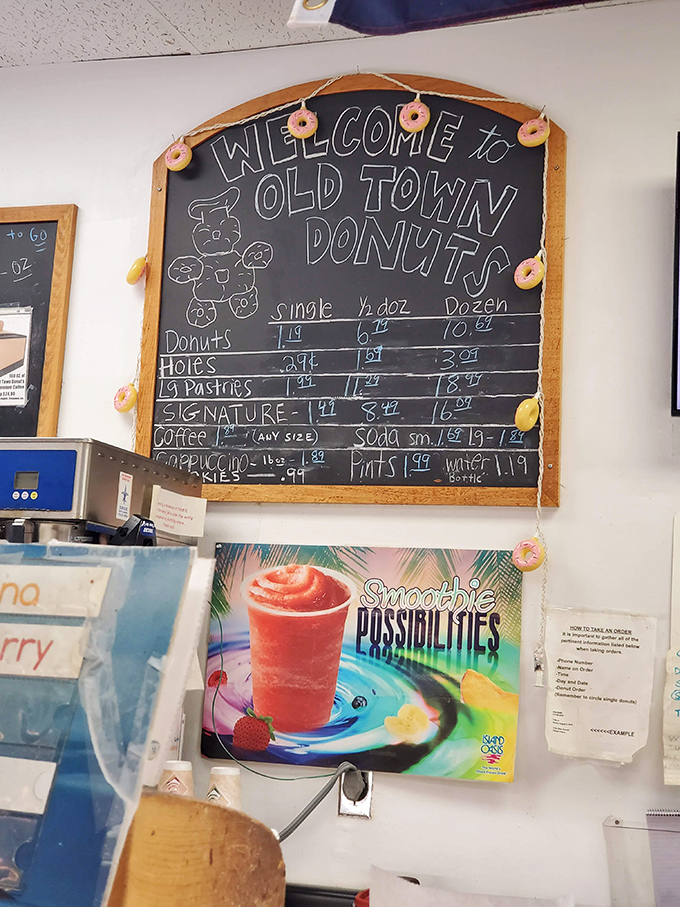 The chalkboard menu adorned with tiny donut decorations - pricing that won't break the bank for a transcendent sugar experience.