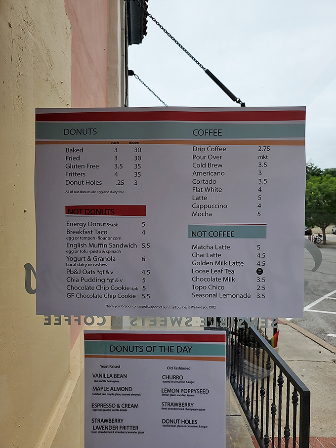 The menu board tells a delicious story in sections: "Donuts," "Not Donuts," and beverages that prove life's important decisions are best made with coffee in hand.