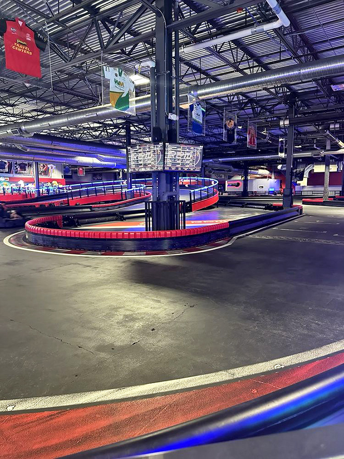 The track's curves and straightaways beckon drivers with the siren song of competition, outlined in glowing red and blue LED lighting.