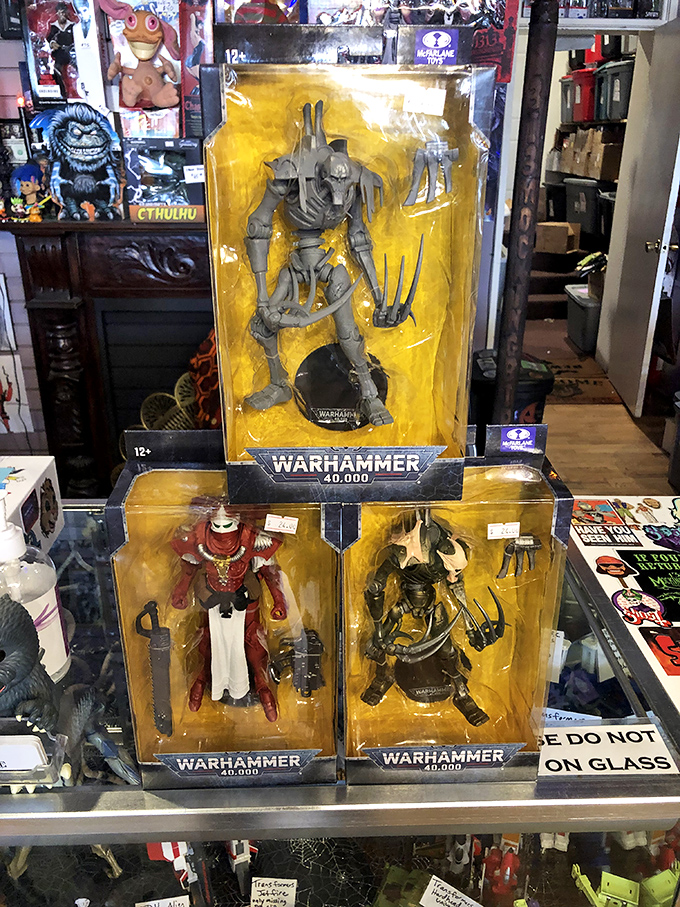 Warhammer 40,000 figures stand at attention, ready to battle in their pristine packaging. These aren't just toys&mdash;they're miniature works of dystopian art for the discerning collector.