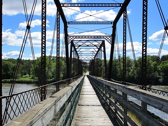 The iron bridge spans more than just the Des Moines River &ndash; it's a portal between centuries, each plank a step back in time.