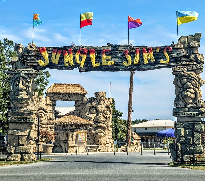 Tiki sentinels stand guard at Jungle Jim's entrance, their weathered faces having witnessed decades of summer memories and gleeful squeals.