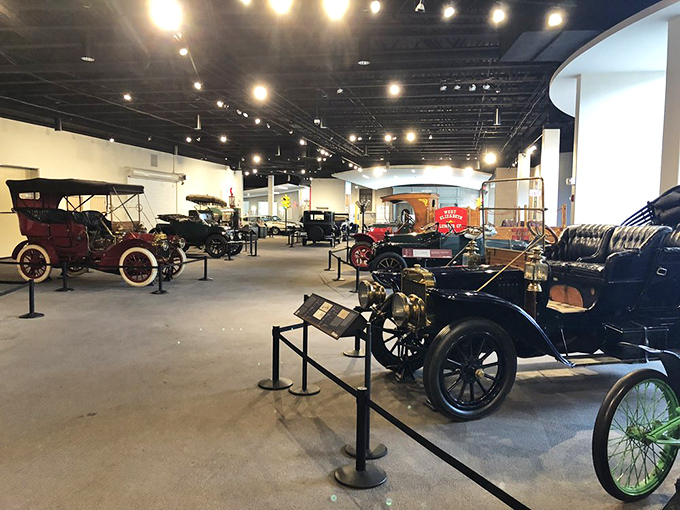 Early automotive pioneers line up like mechanical celebrities on a chrome-and-rubber red carpet, each with stories to tell.