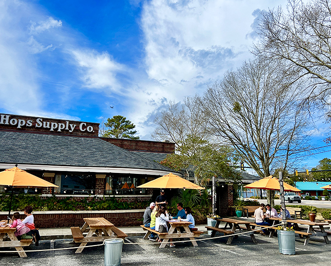 At Hops Supply Co., outdoor dining becomes an art form. Those yellow umbrellas aren't just for show&mdash;they're beacons for hungry travelers.