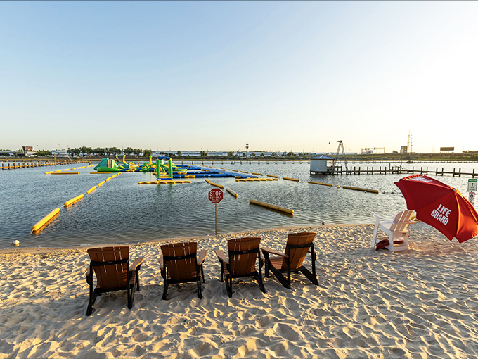 Beach chairs await tired adventurers, with the inflatable obstacle course taunting from a safe distance. "Come back when you've caught your breath!"