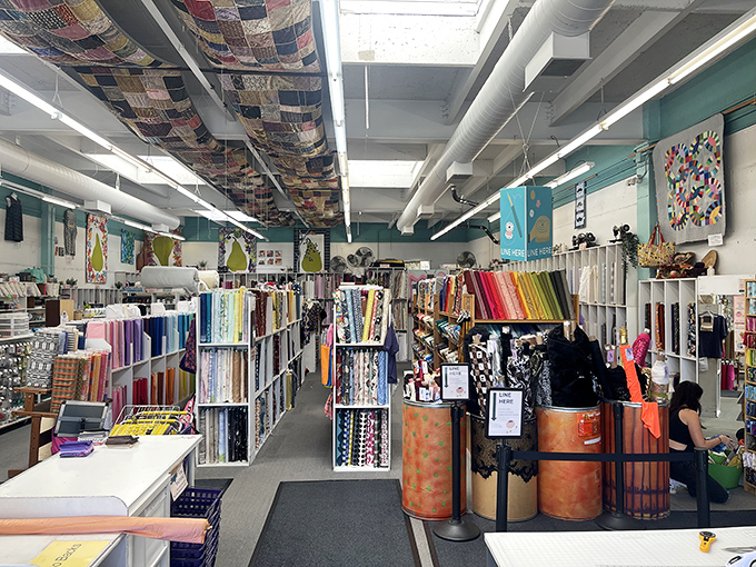 Fabric heaven exists, and it has quilts hanging from the ceiling. This textile wonderland makes even non-sewers contemplate taking up the craft.