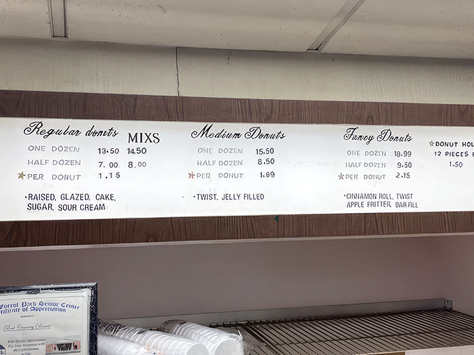 The menu board speaks a language all donut lovers understand: Regular, Medium, Fancy. No PhD in pastry required.