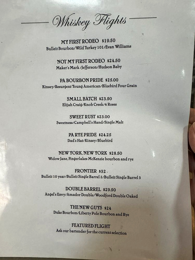 The whiskey flight menu reads like poetry for adults. "My First Rodeo" to "Frontier"&mdash;each one a liquid journey paired with smoky delights.
