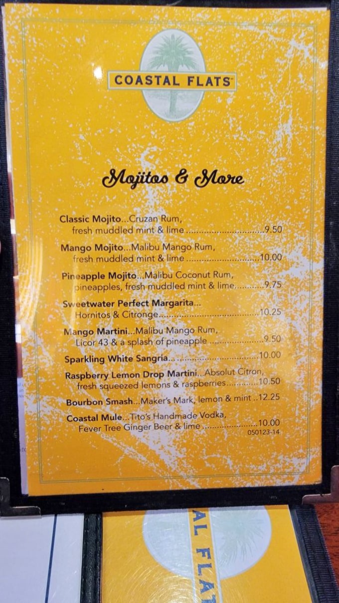 The vibrant yellow cocktail menu promises tropical escape with every sip. Decisions, decisions&mdash;like choosing between beach reads for a weekend getaway.