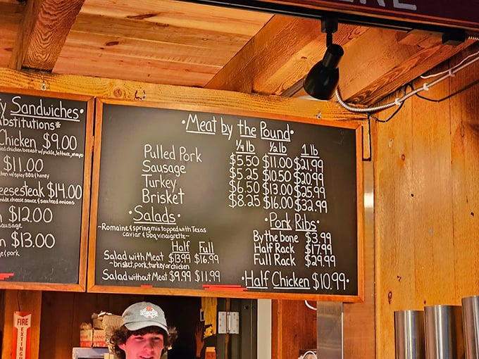 The chalkboard menu speaks the universal language of barbecue mathematics: more meat equals more happiness, with proof in every pound.