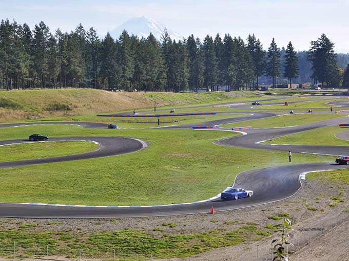 Mount Rainier watches over this asphalt playground where cars and karts dance through a symphony of turns designed to test your mettle.