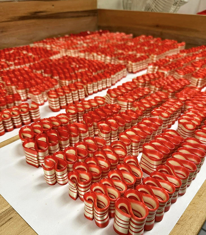 These hypnotic red and white ribbon candies aren't just treats—they're edible art, handcrafted the same way since your grandparents were sneaking sweets.